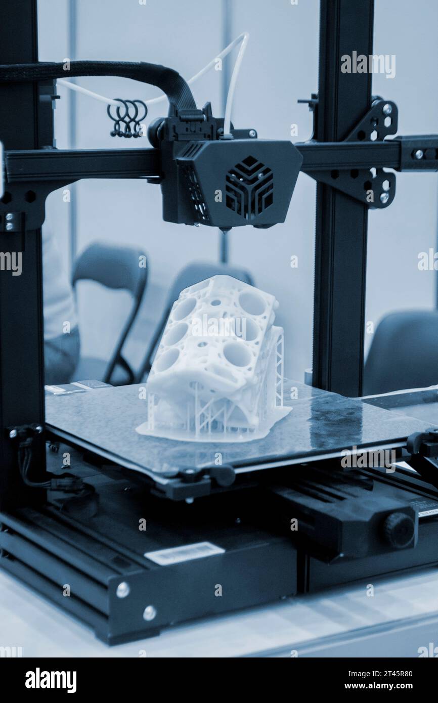 Prototype of car engine printed on 3D printer from molten white plastic ...