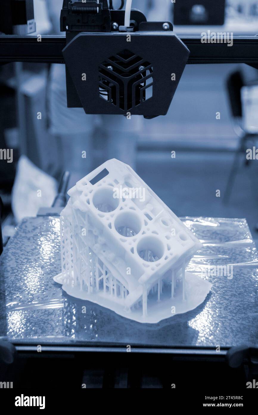 Prototype of car engine printed on 3D printer from molten white plastic ...