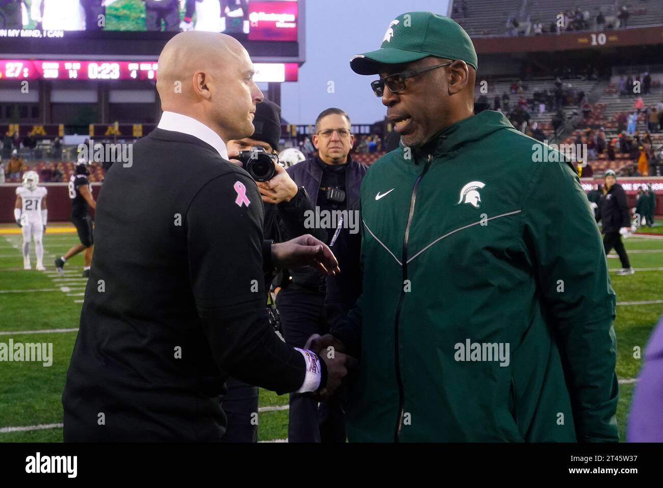 Minnesota head coach P. J. Fleck, left, and Michigan State interim head ...