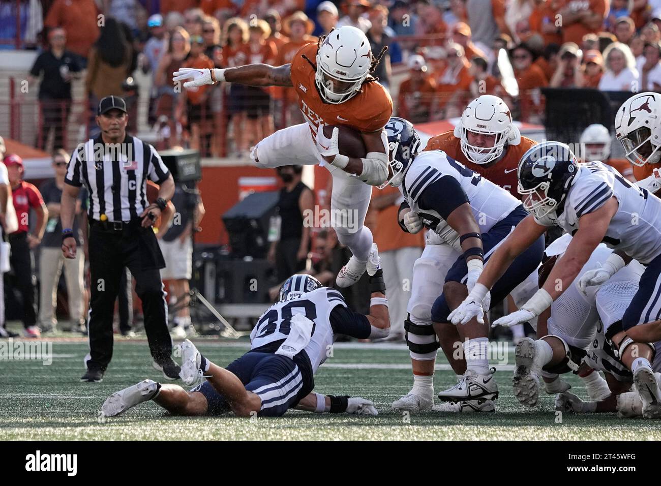 Texas running back Jonathon Brooks (24) is upended by BYU safety Crew ...