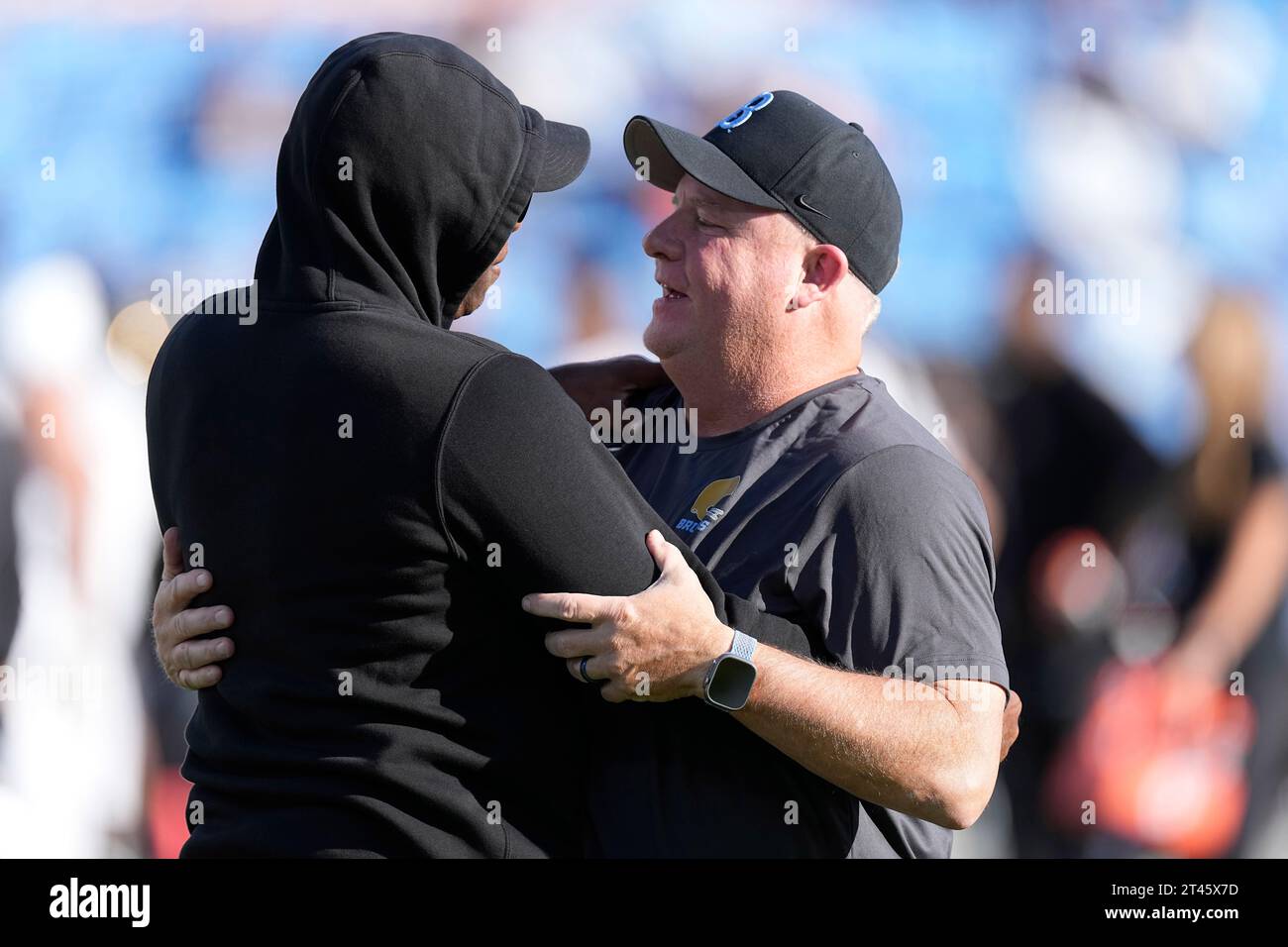Colorado head coach Deion Sanders, left, greets UCLA head coach Chip ...