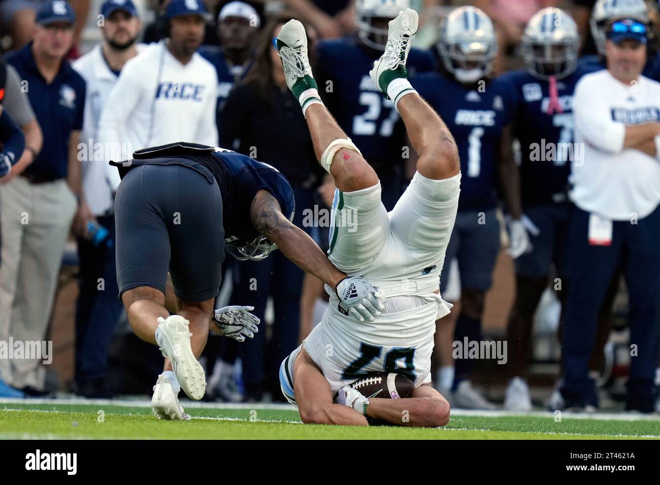Tulane tight end Alex Bauman, right, lands after flipping as Rice ... Tulane tight end Alex Bauman, right, lands after flipping as Rice ...