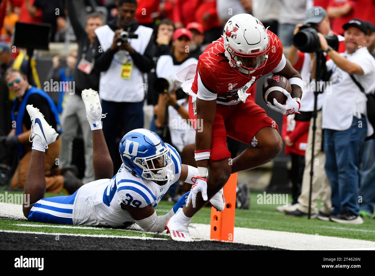 Louisville running back Jawhar Jordan, right, fights his way through ...