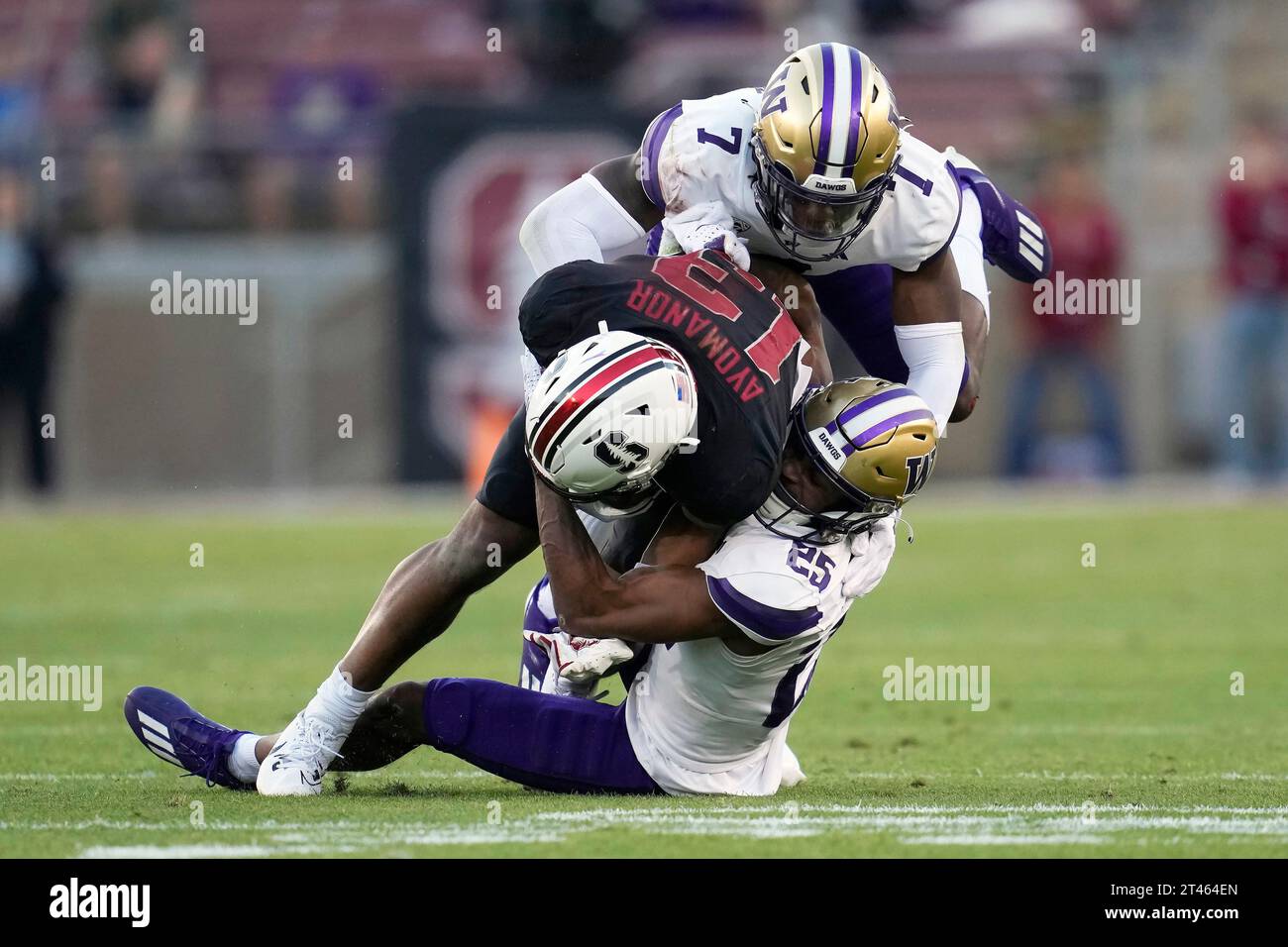 Stanford wide receiver Elic Ayomanor, middle, is tackled by Washington ...