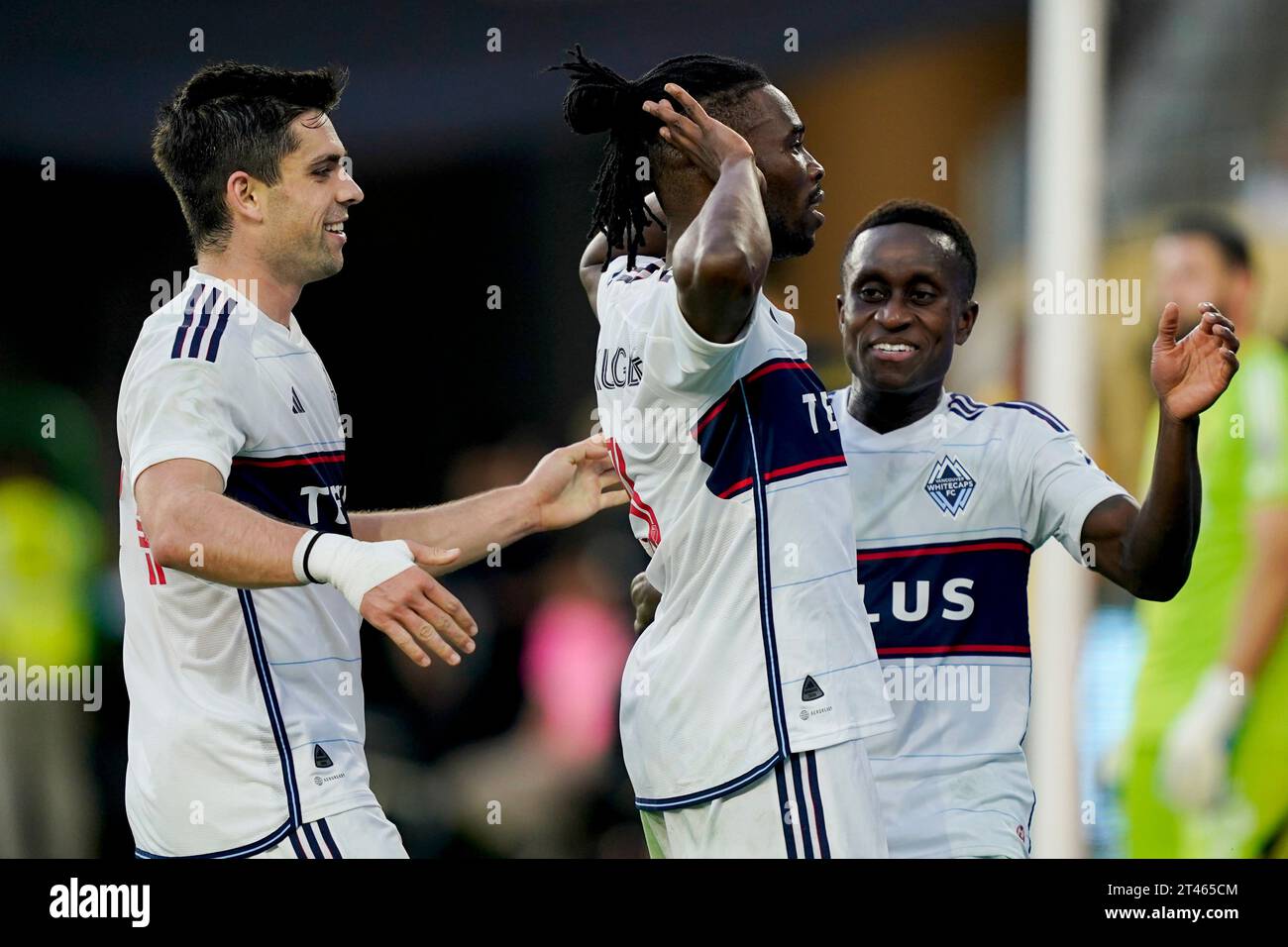 Vancouver Whitecaps defender Sam Adekugbe, center, celebrates his goal ...