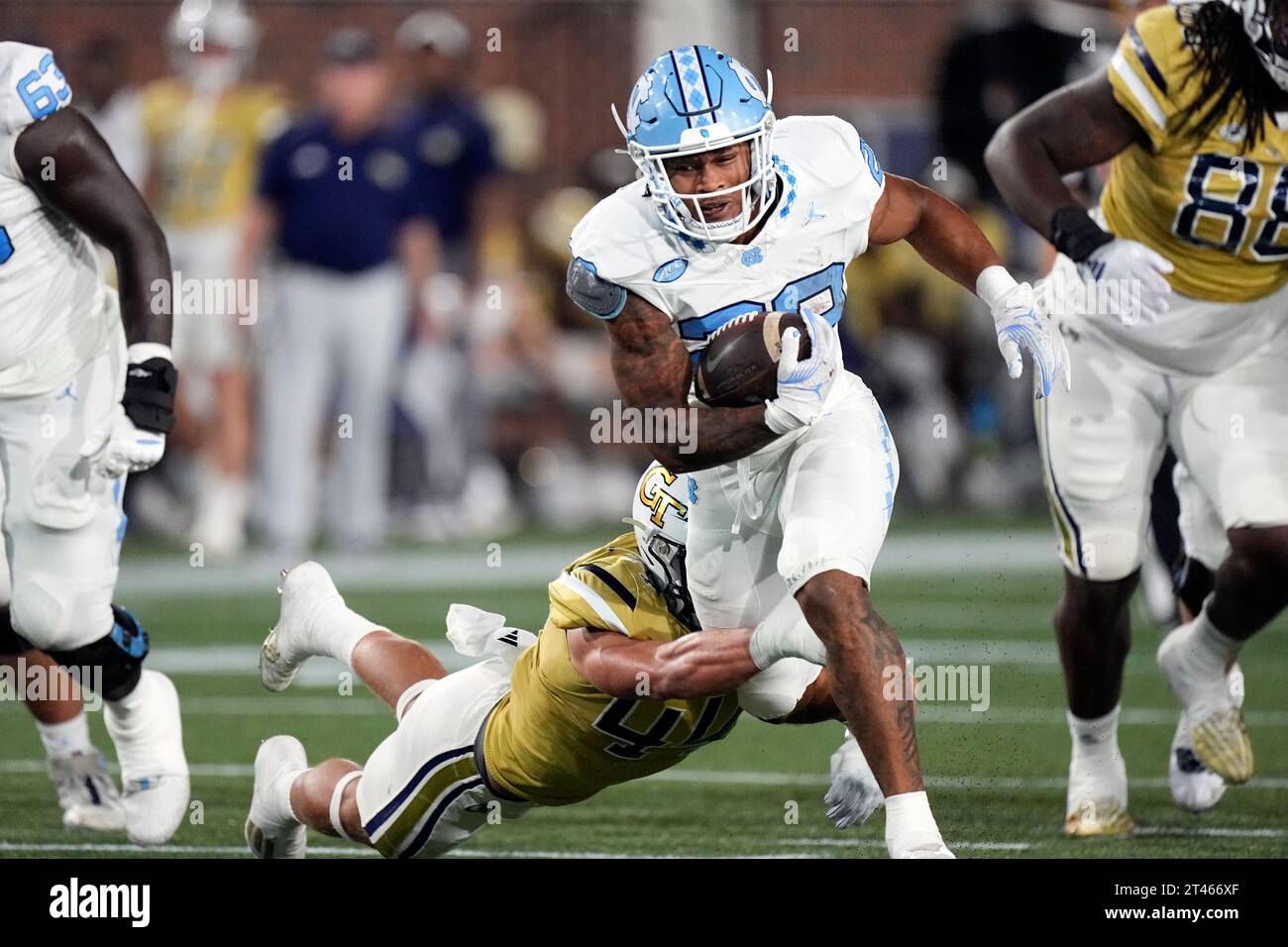 North Carolina running back Omarion Hampton (28) tries to escape from ...