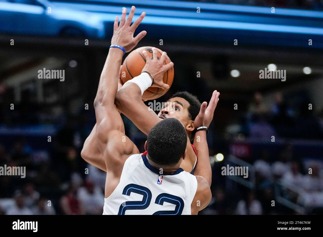 Washington Wizards guard Jordan Poole, top, looks to shoot over Memphis ...
