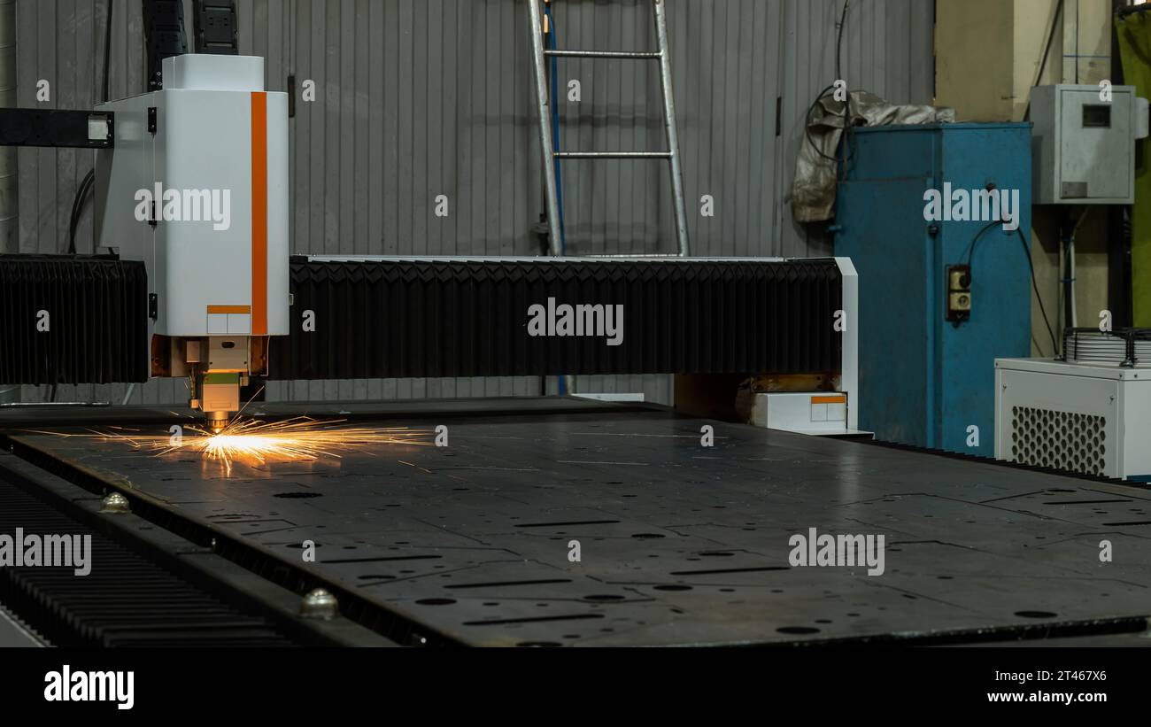 CNC machine. Laser cutting of metal. Sparks Stock Photo - Alamy