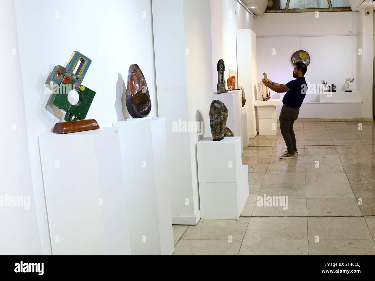 Baghdad, Iraq. 28th Oct, 2023. A visitor takes photos of ceramic works ... Baghdad, Iraq. 28th Oct, 2023. A visitor takes photos of ceramic works ...