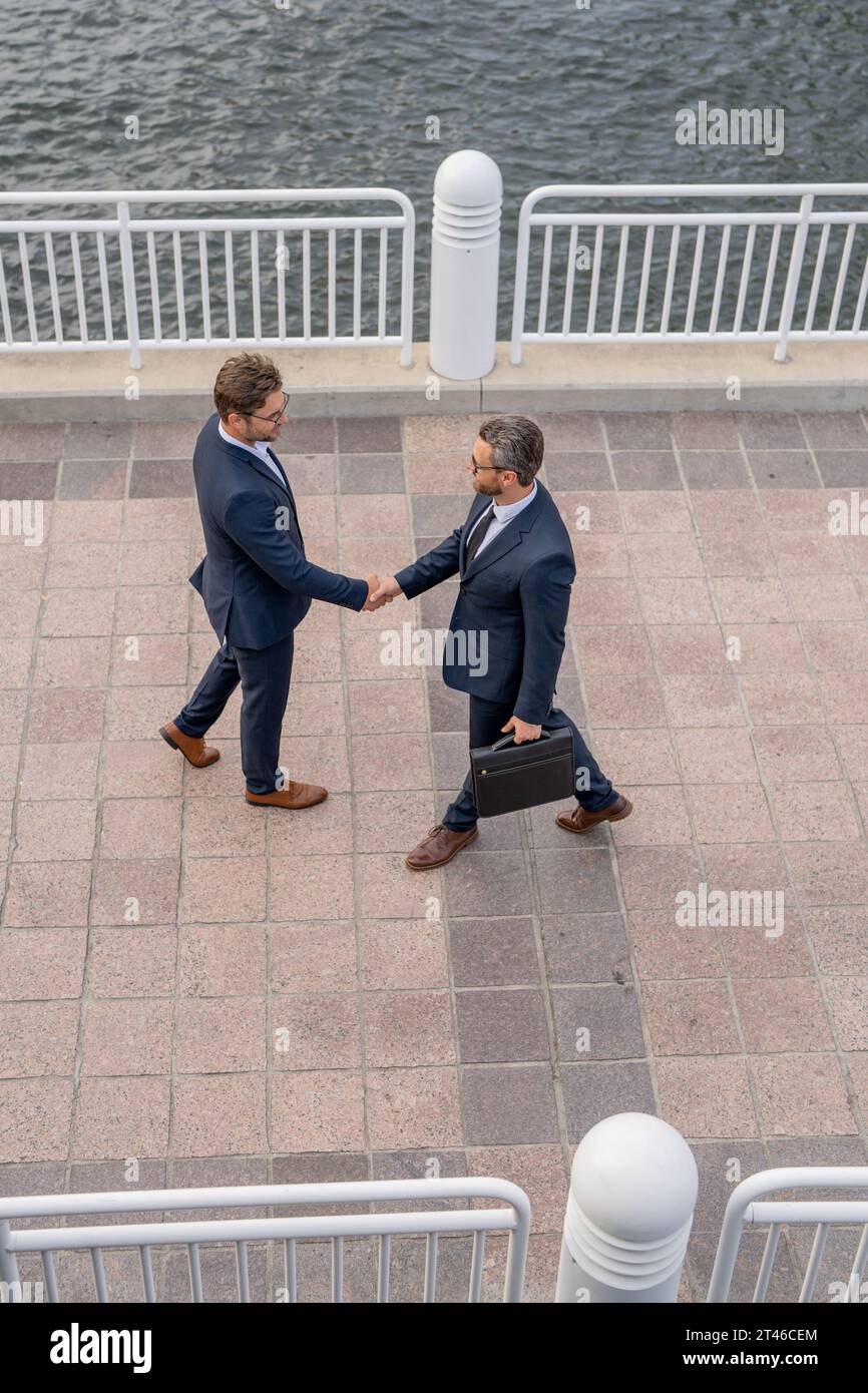Handshake with partner in the city for greeting. Businessmen in suit ...