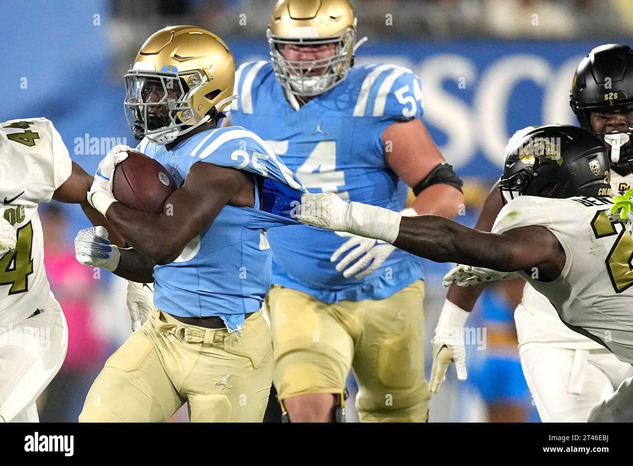 UCLA running back TJ Harden, left, breaks away from Colorado linebacker ...