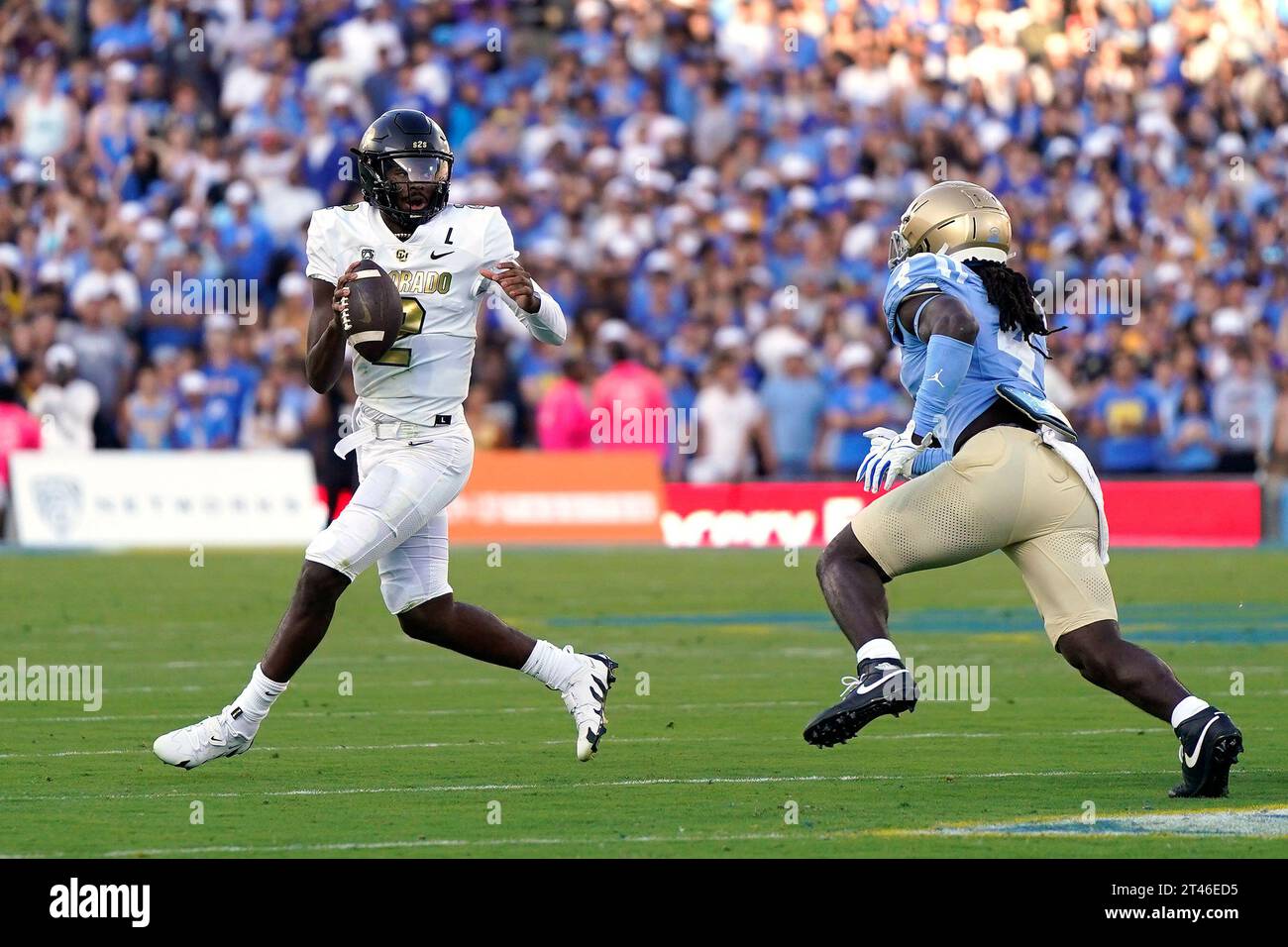 Colorado quarterback Shedeur Sanders, left, tries to pass as UCLA ...