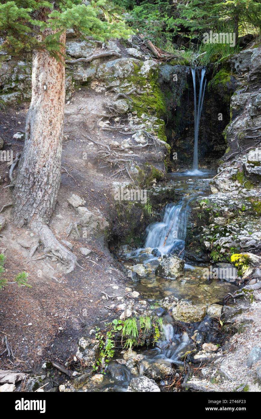 A small waterfall pouring over a small cliff along the North Rim Trail ...