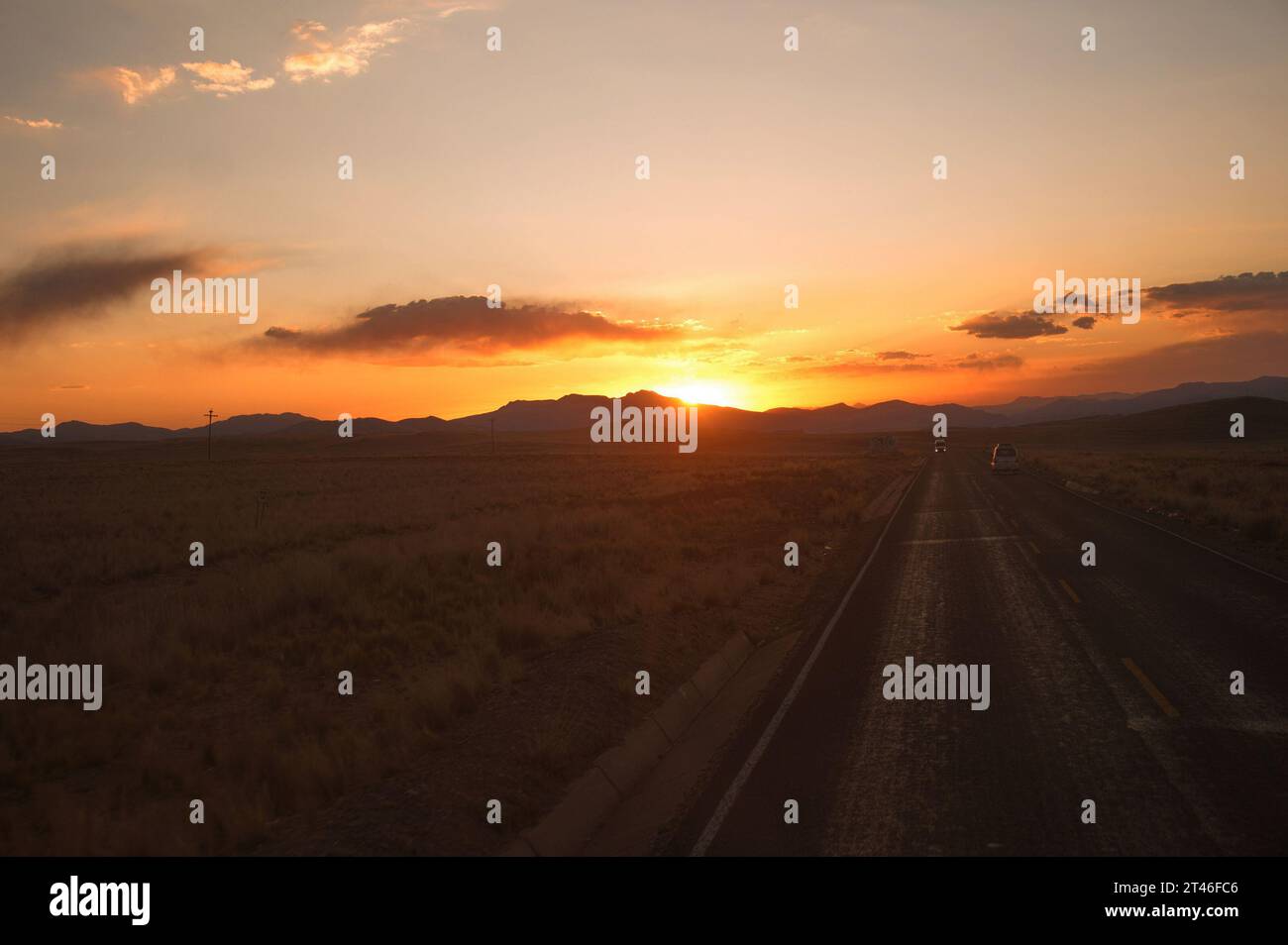 Sunset view through the bus window of a road through the highlands of ...