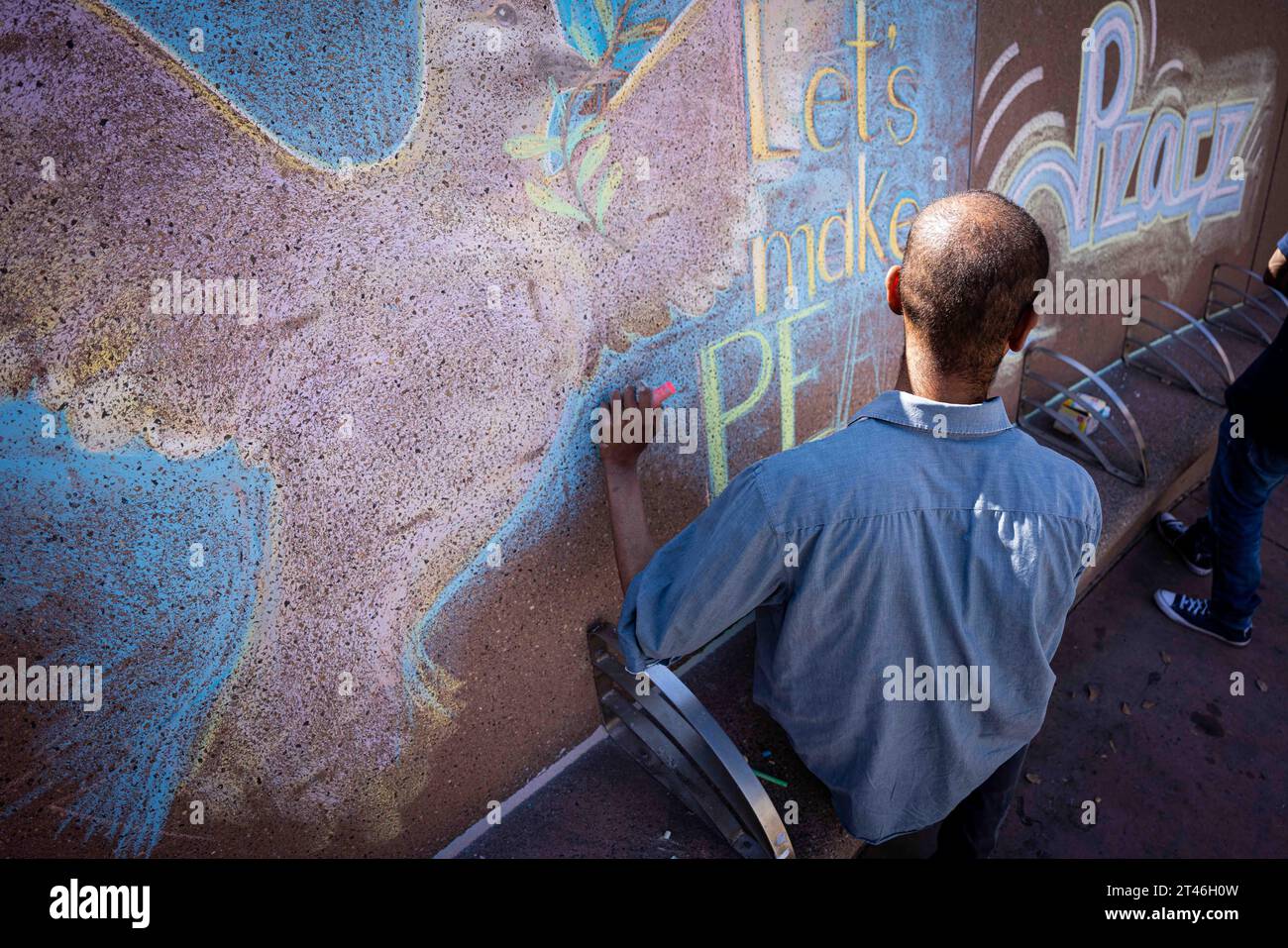 Los Angeles, California, USA. 28th Oct, 2023. A man uses chalk to ...