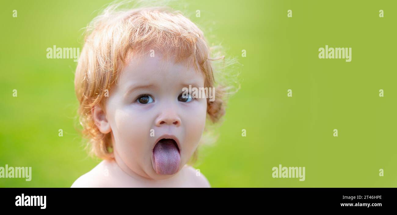 Baby on spring grass field, banner. Funny child in park. Baby face with ...
