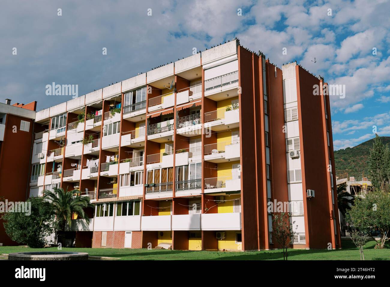 Tenement house on a green lawn overlooking the mountains Stock Photo ...