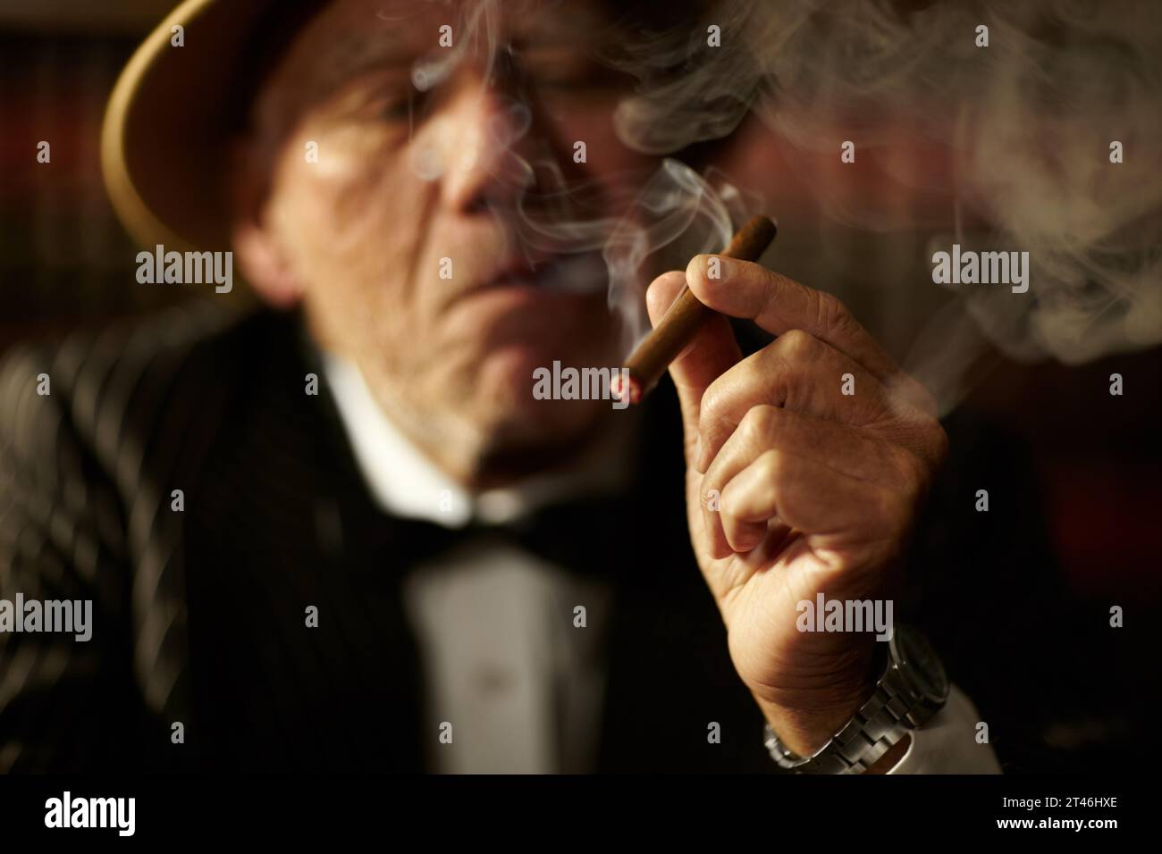 Old man, smoking and cigarette in hand with smoke and crime boss of mob ...