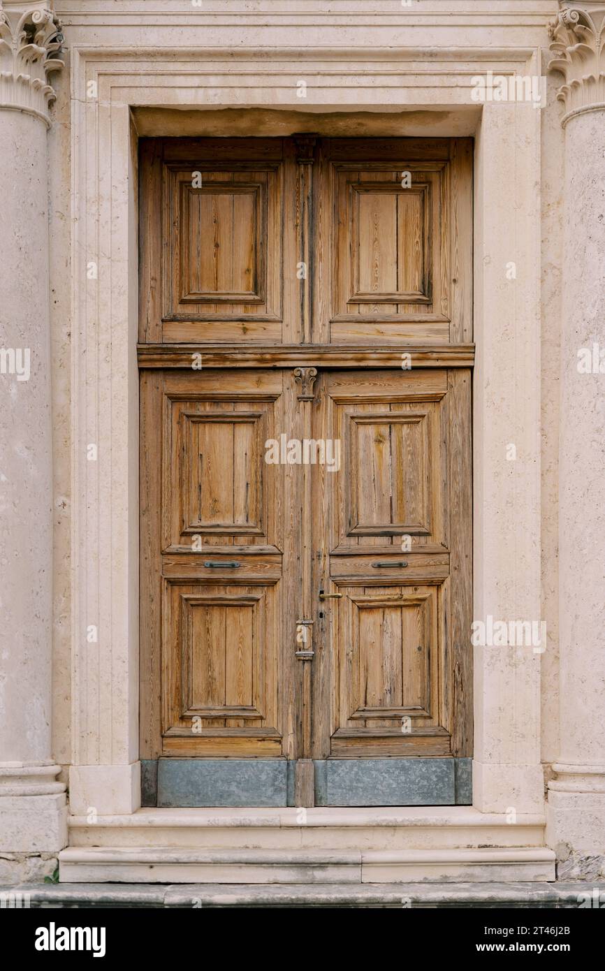 Carved wooden door of an ancient church with columns and stucco Stock ...