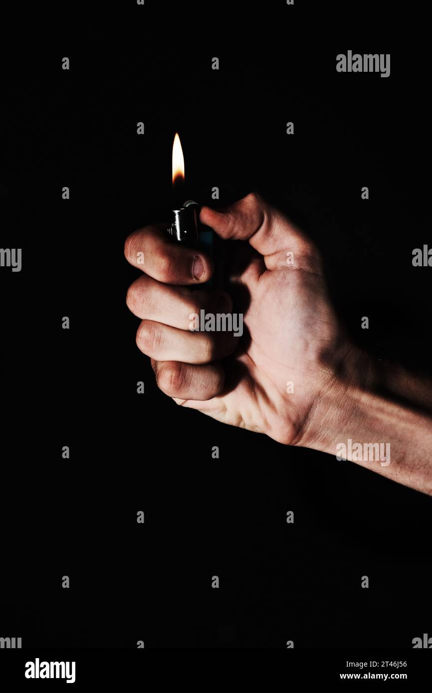 Hand, lighter and fire on black background, heat or warm element ...
