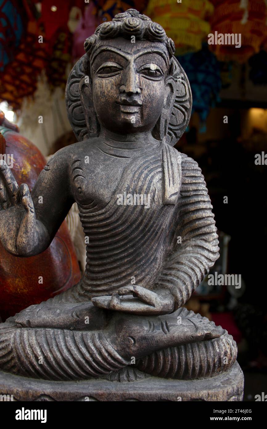 Wooden buddha statue, on grey cement background/Buddha statue on the ...