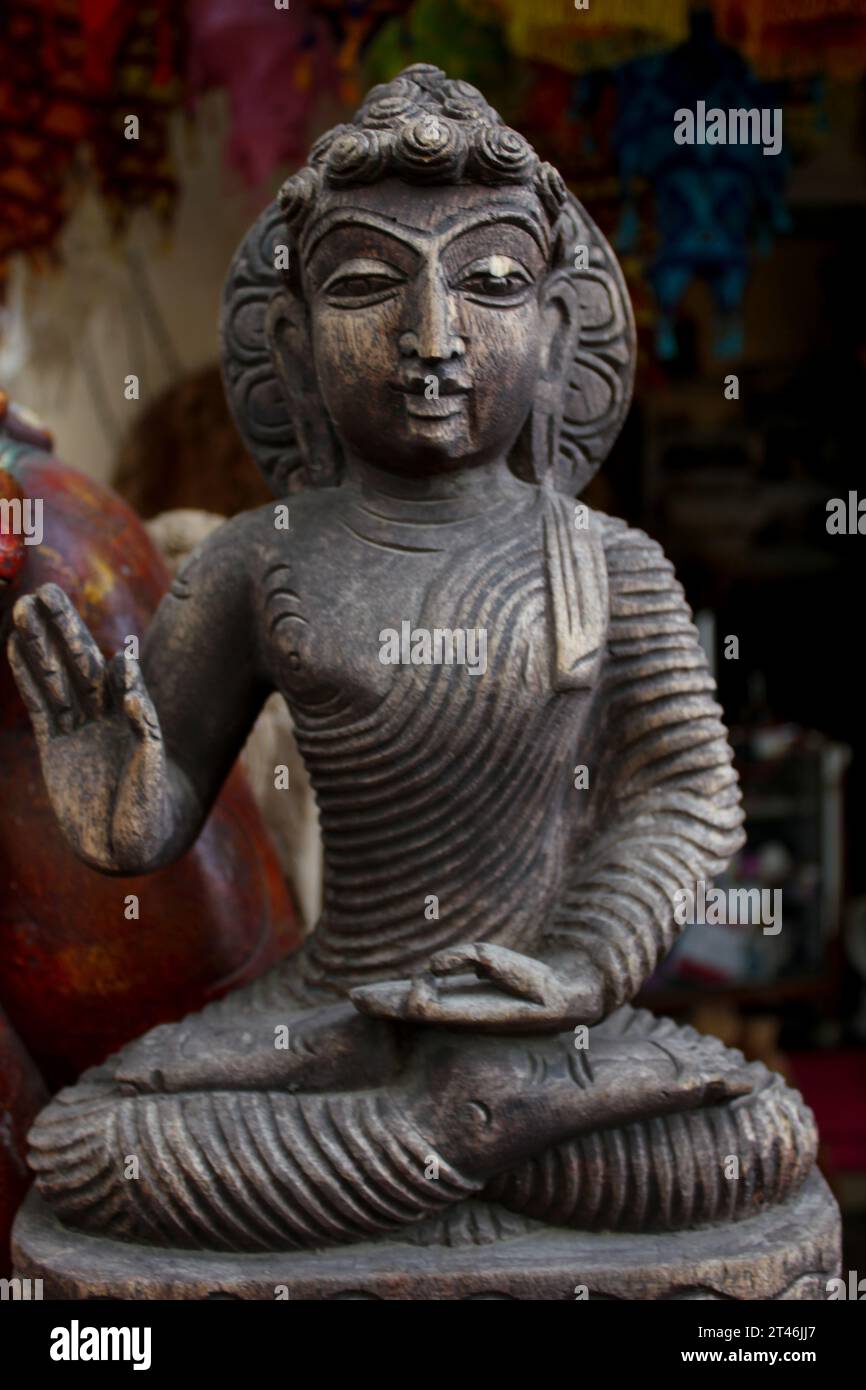 Wooden buddha statue, on grey cement background/Buddha statue on the ...
