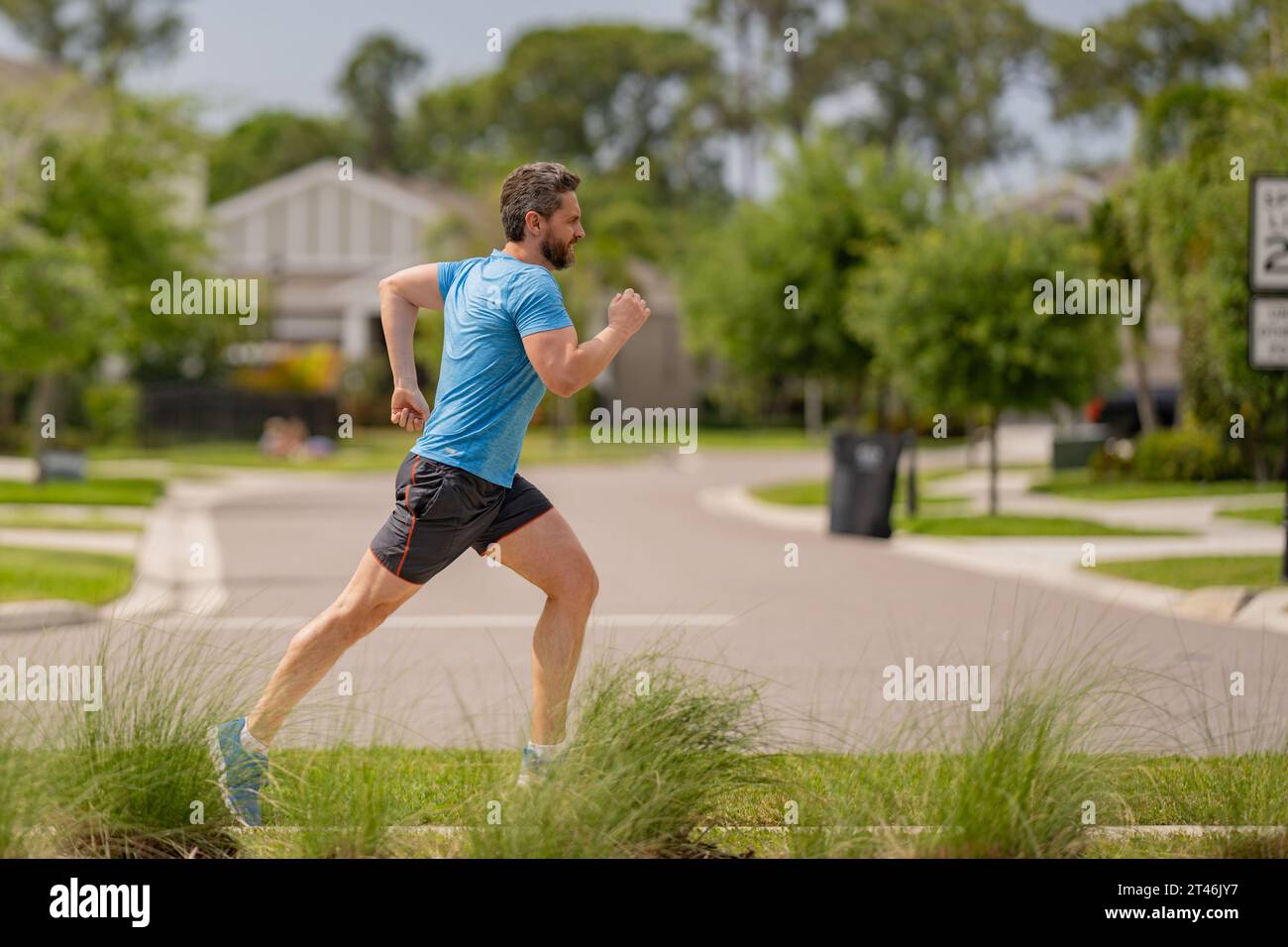 Male jogger running in park. Full length portrait of an athletic young ...