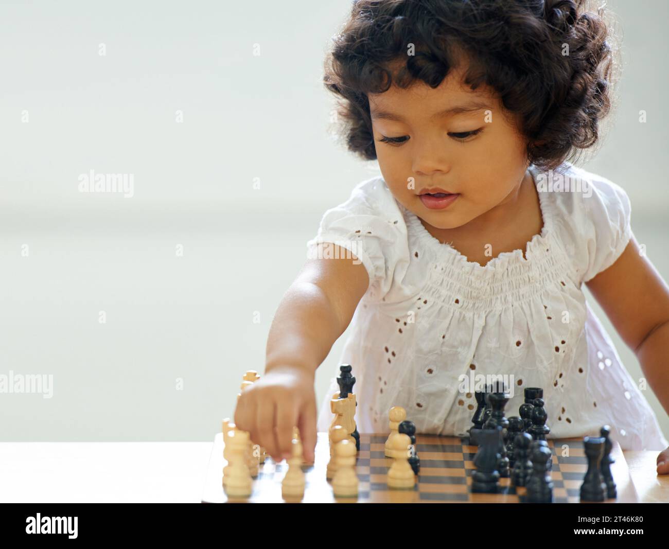 Girl, child and chess play for learning growth, childhood development ...