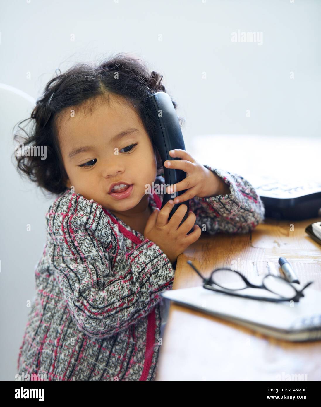 Playing, talking and a child on a telephone for communication, pretend ...