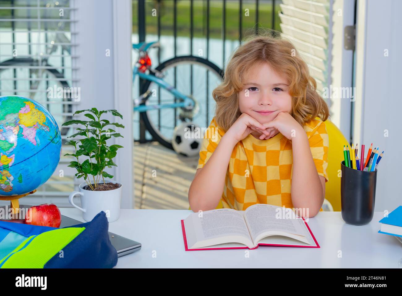 Child reading book. School child studying at home. Kid studying on ...