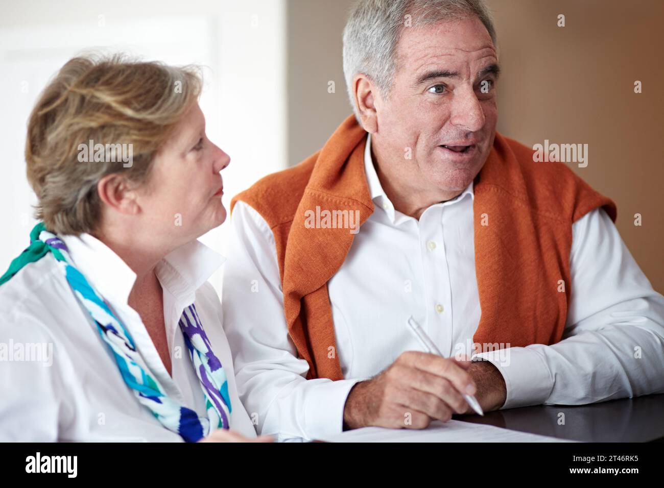 Sign in, hotel and senior couple by reception to check in desk for love ...