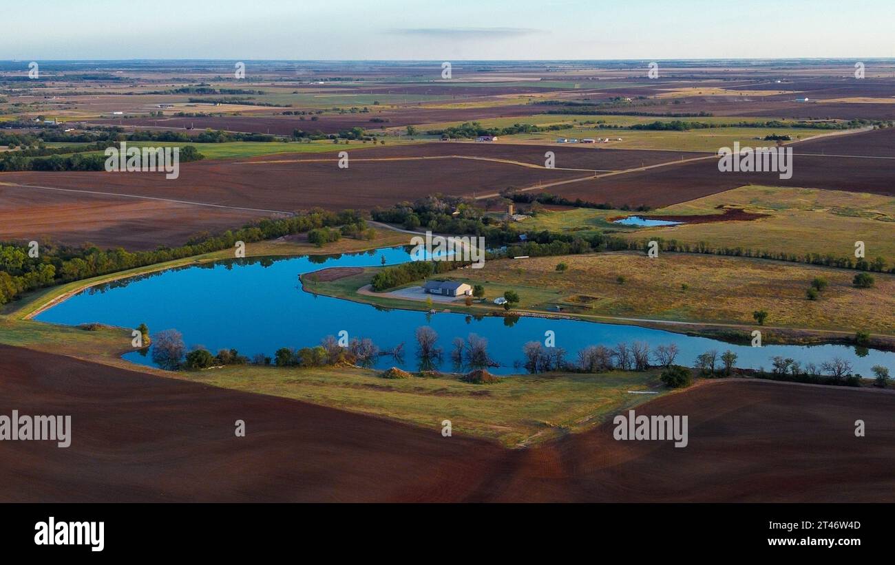 A scenic view of a lush, sprawling meadow with trees and shrubbery ...