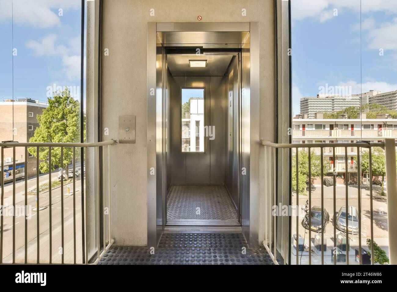 an elevator in a building with blue sky and white clouds behind the ...