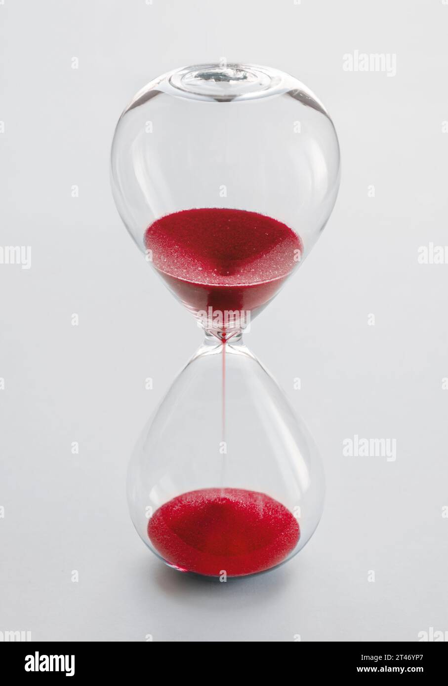 Hourglass flow on red background hi-res stock photography and images ...