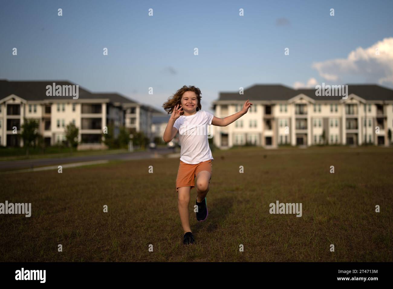 Child run. Excited kid boy running on grass. Kid boy playing and ...