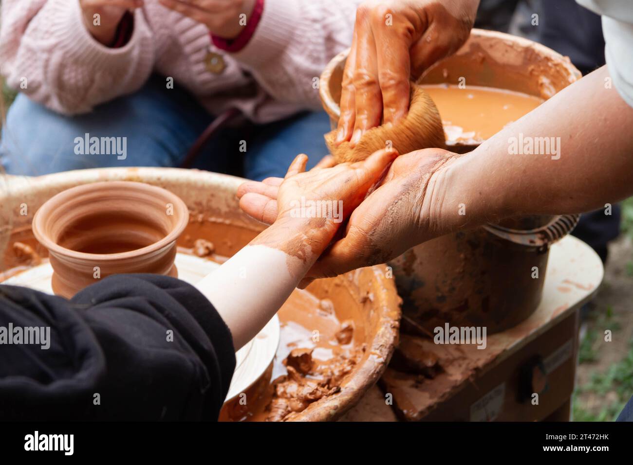 Pottery training. Rotating a clay pot on a machine. Hands knead clay ...