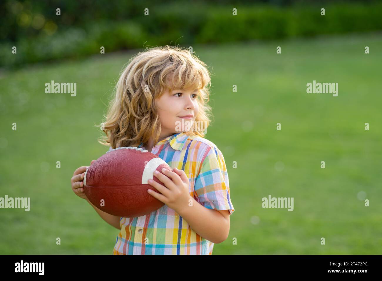 Portrait of child with rugby ball. American football. Child ready to ...