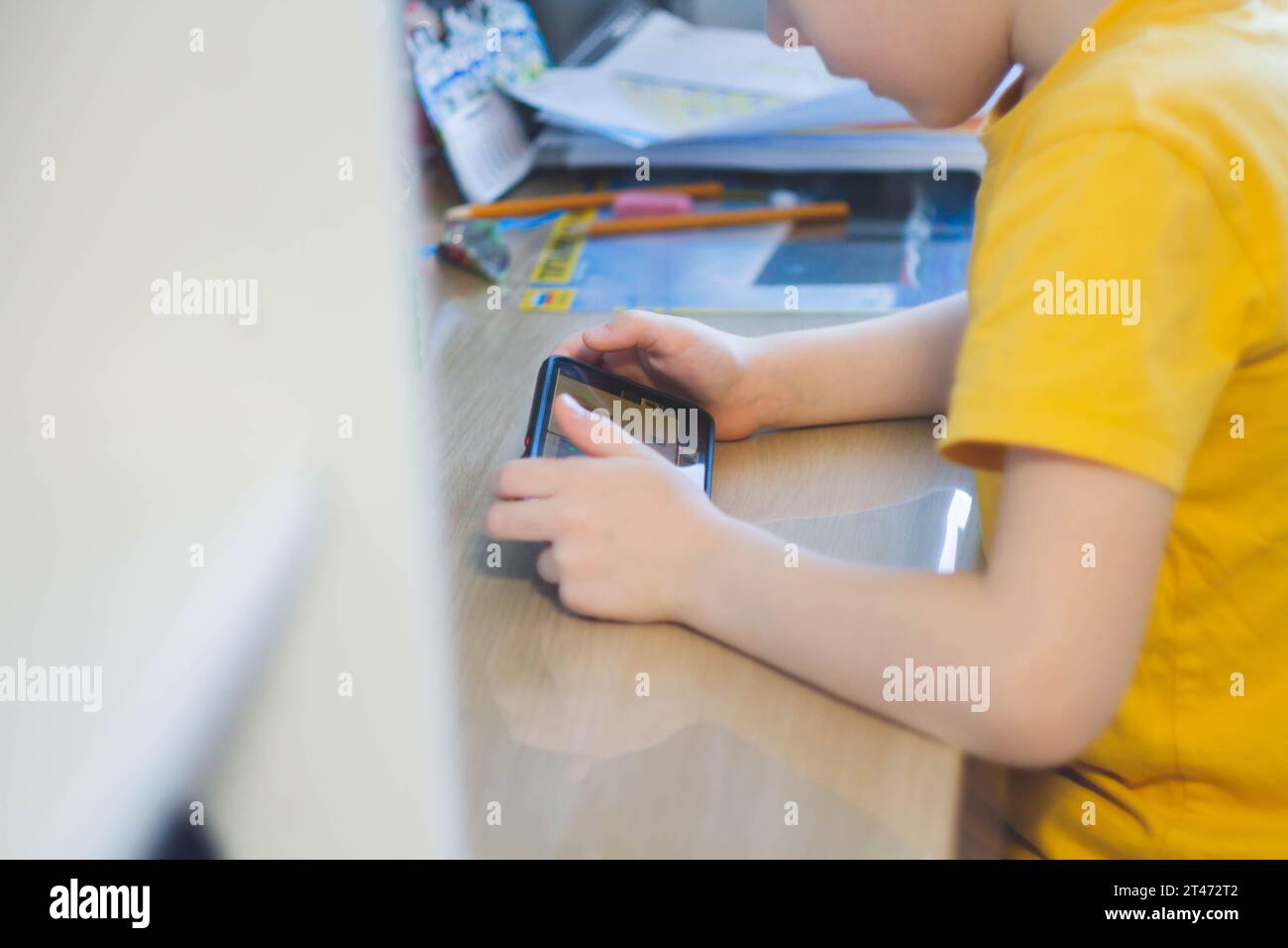 Phone in hands of child. Little boy playing mobile games on smartphone ...