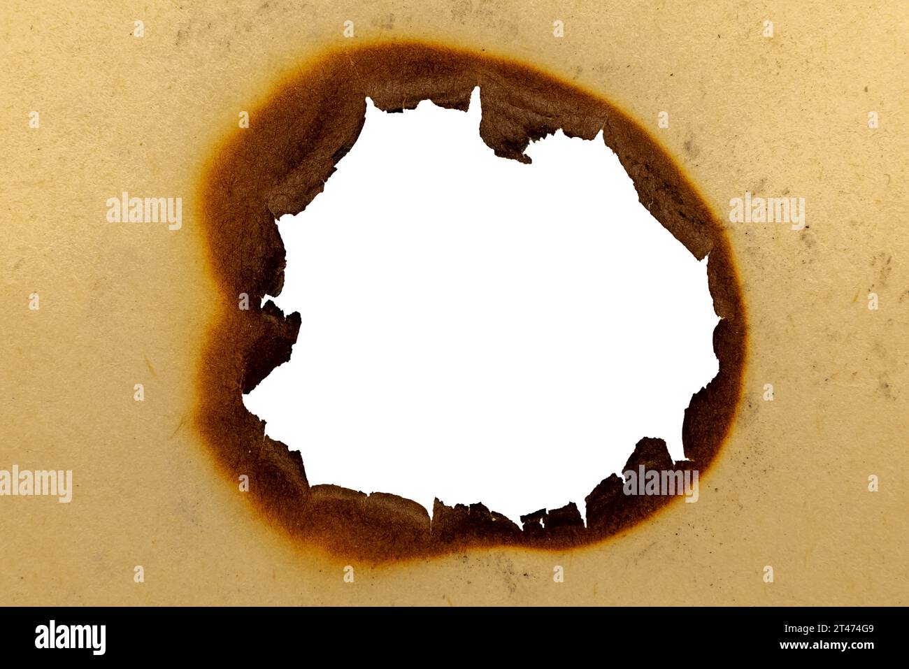 Burnt hole in yellow paper. Burnt paper Stock Photo - Alamy