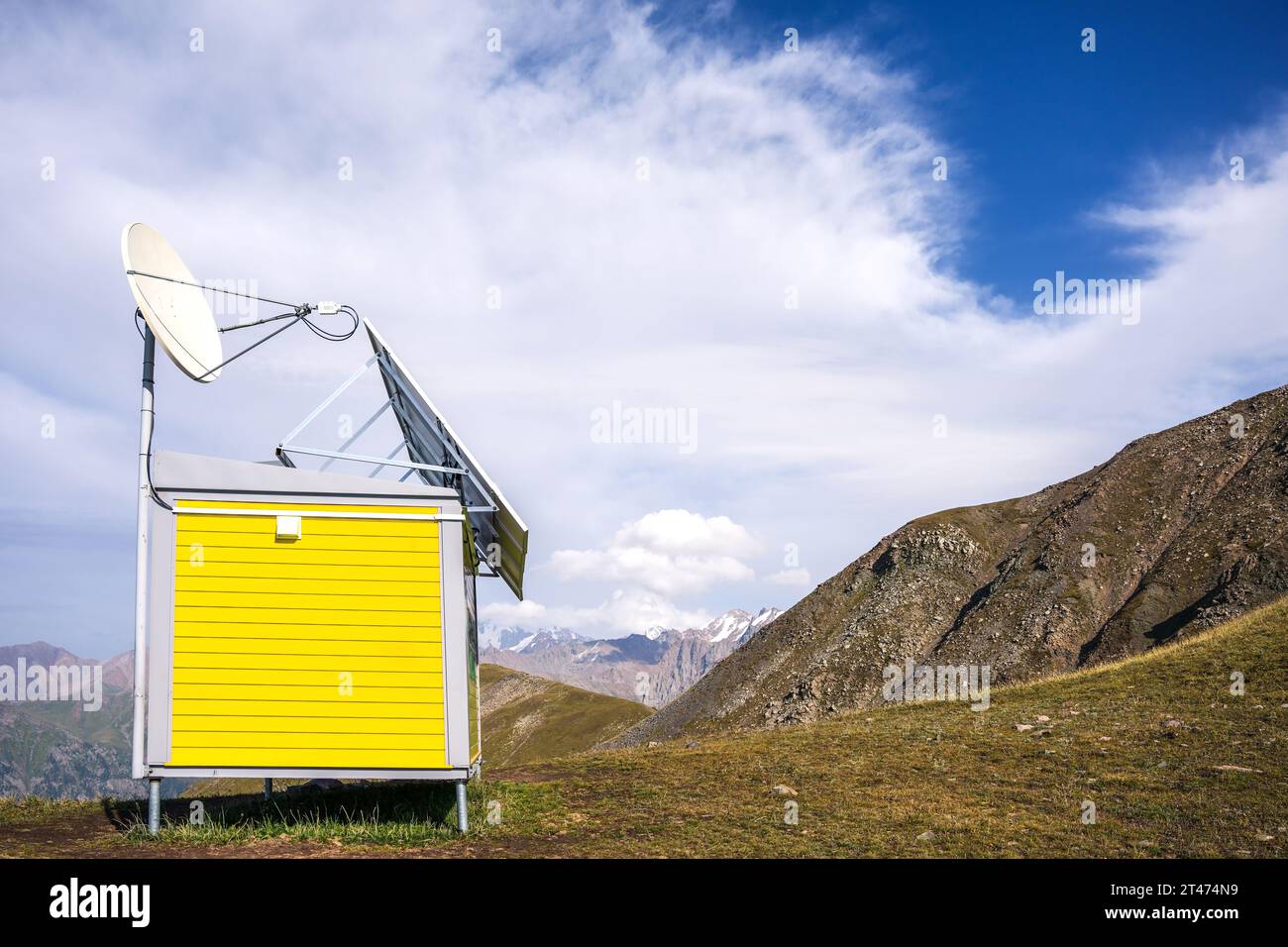 Solar batteries and antenna on the roof of a lodge in the mountains ...