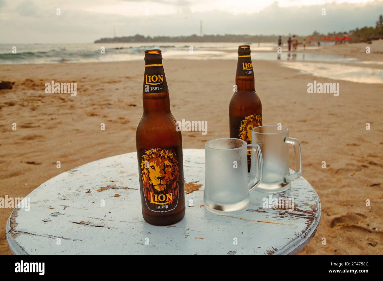 Two bottles of Lion beer and chilled glasses on a table in Tangalle in ...