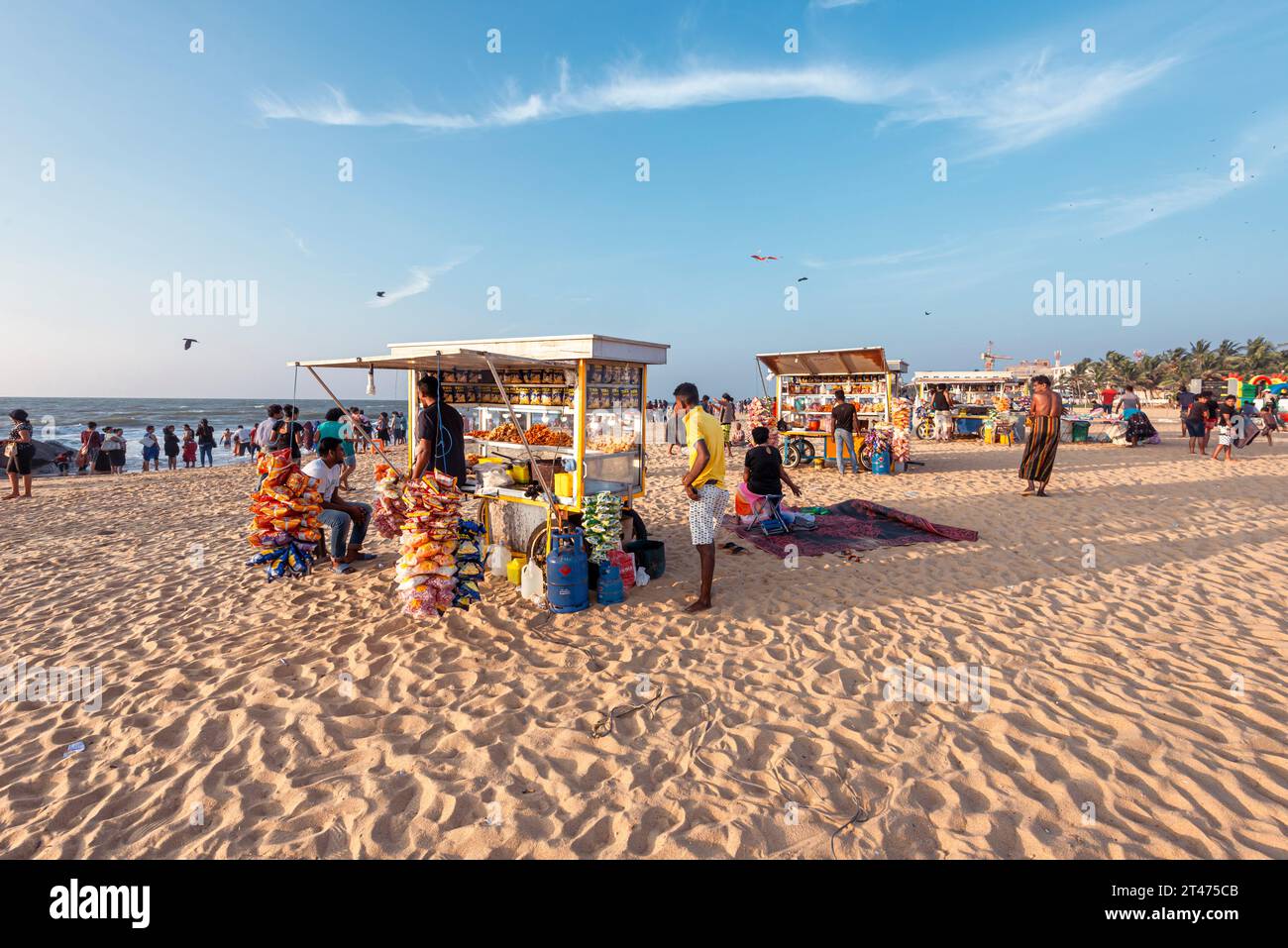 Stalls selling local produce set up on the beach in the evening on ...
