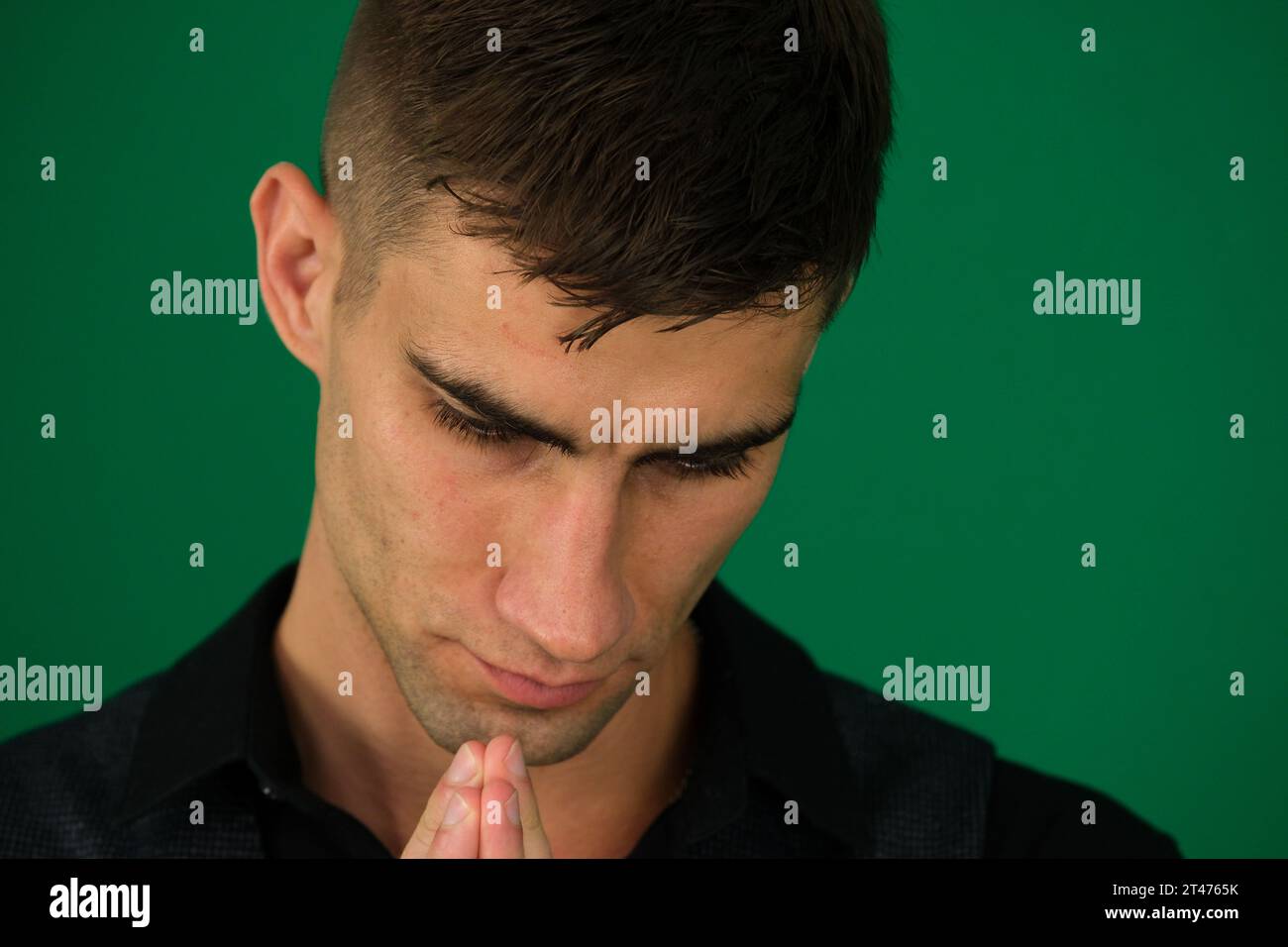 emotions of a handsome man guy on a green background chromakey close-up ...