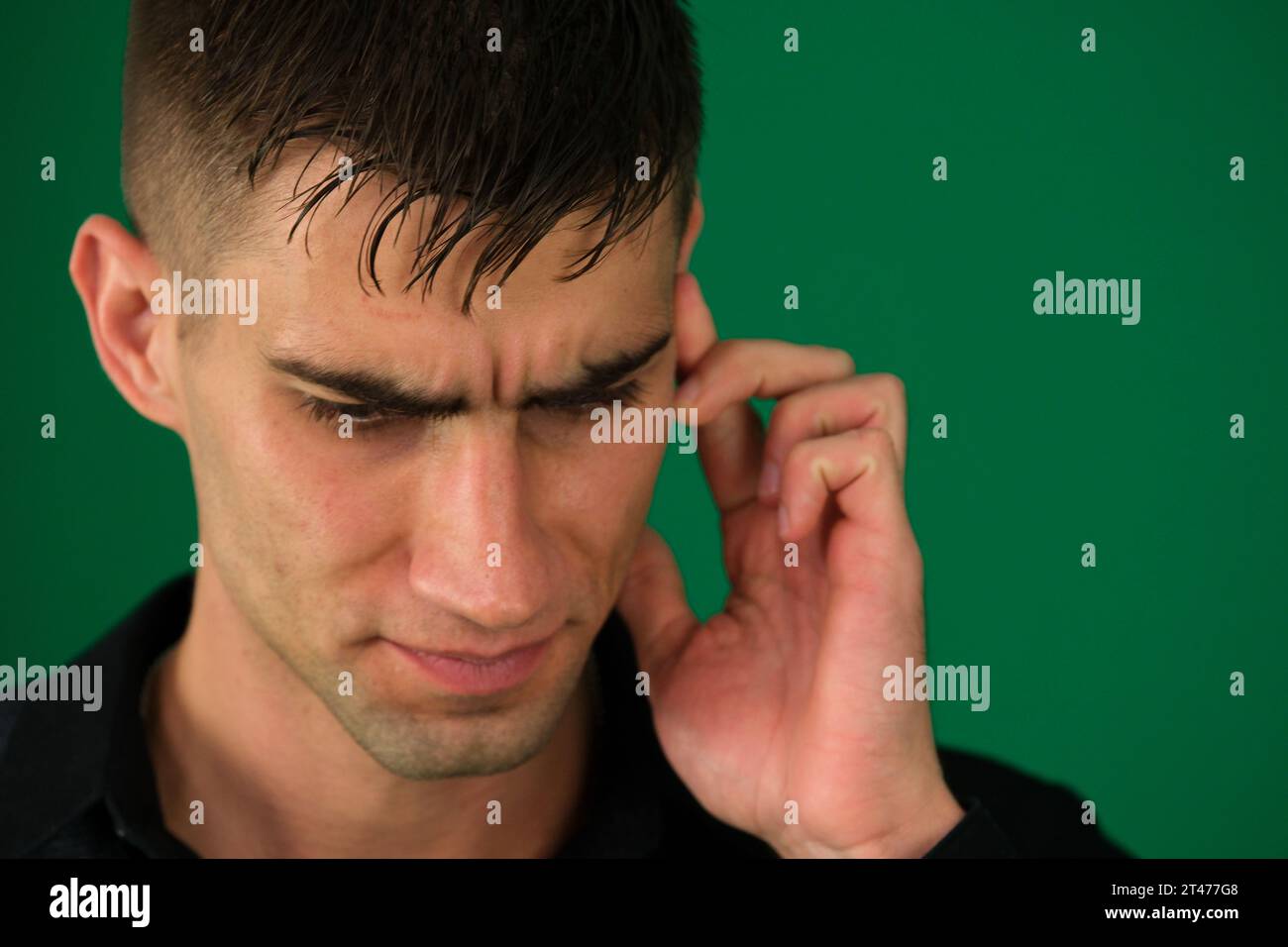 emotions of a handsome man guy on a green background chromakey close-up ...