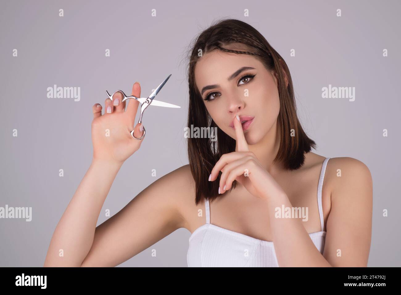 Beautiful woman with hairdresser scissors cutting hair Stock Photo - Alamy
