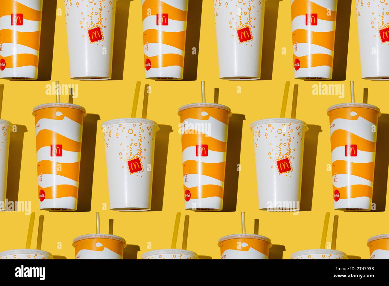 Yellow glass of McDonald's. Paper cup with lid. Takeaway drink ...