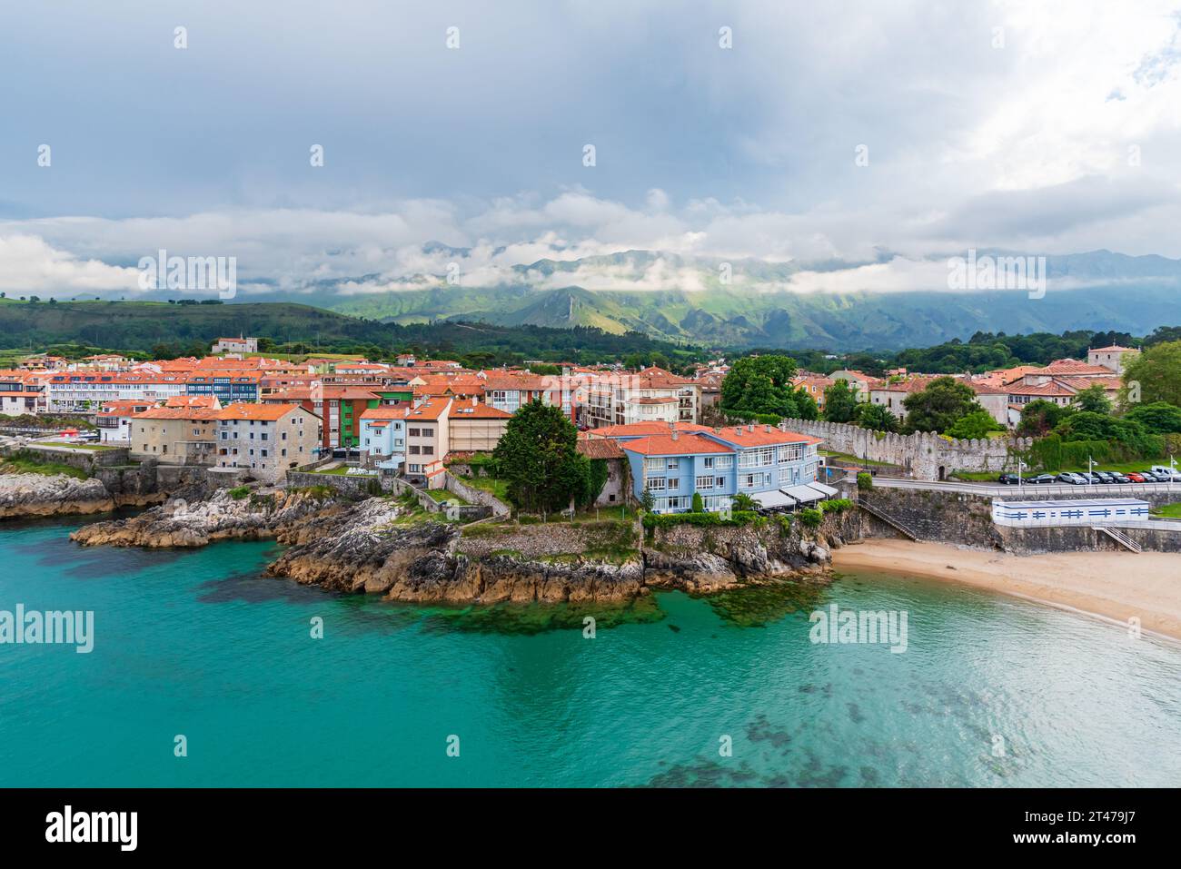 Sablon beach and the city of Llanes with the Cantabrian mountain range ...