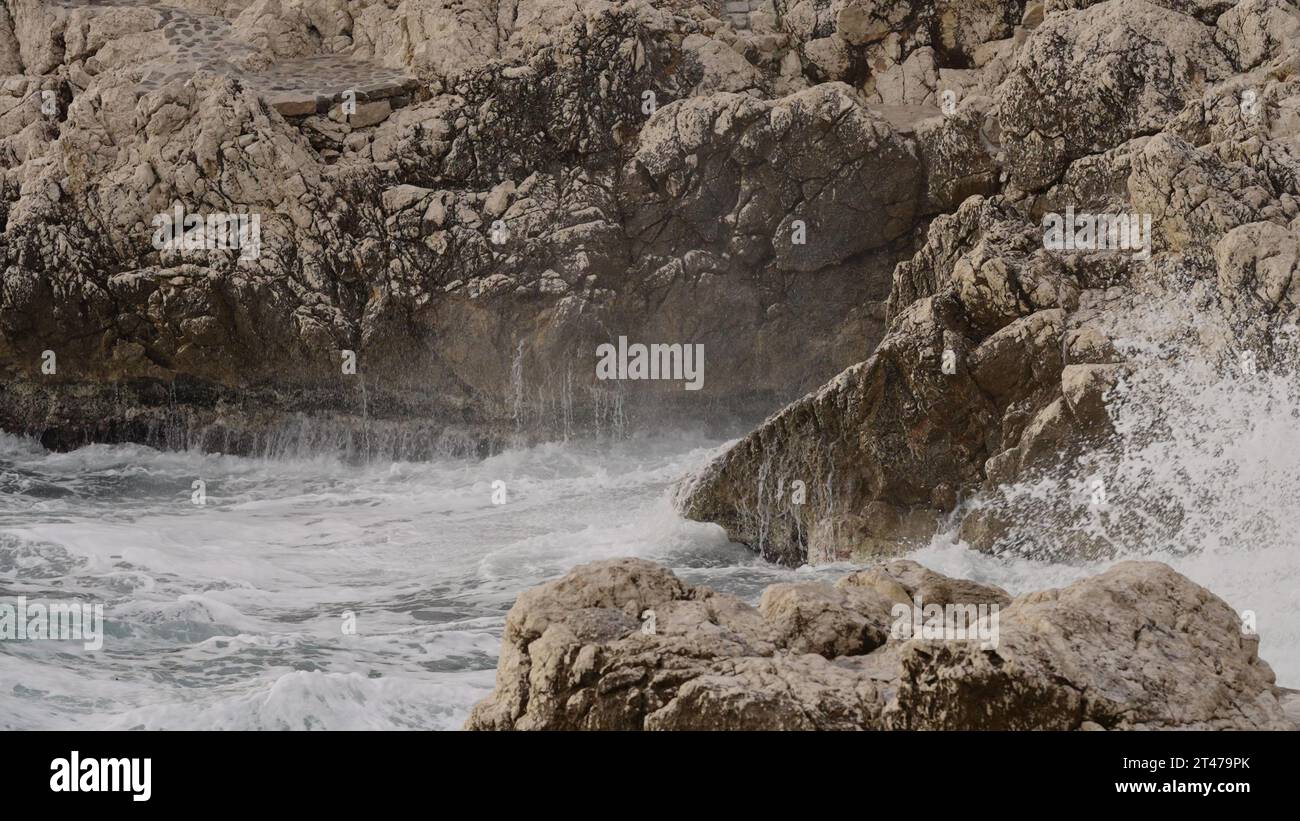 sea waves crushing over rocks with soft light, wide photo Stock Photo ...