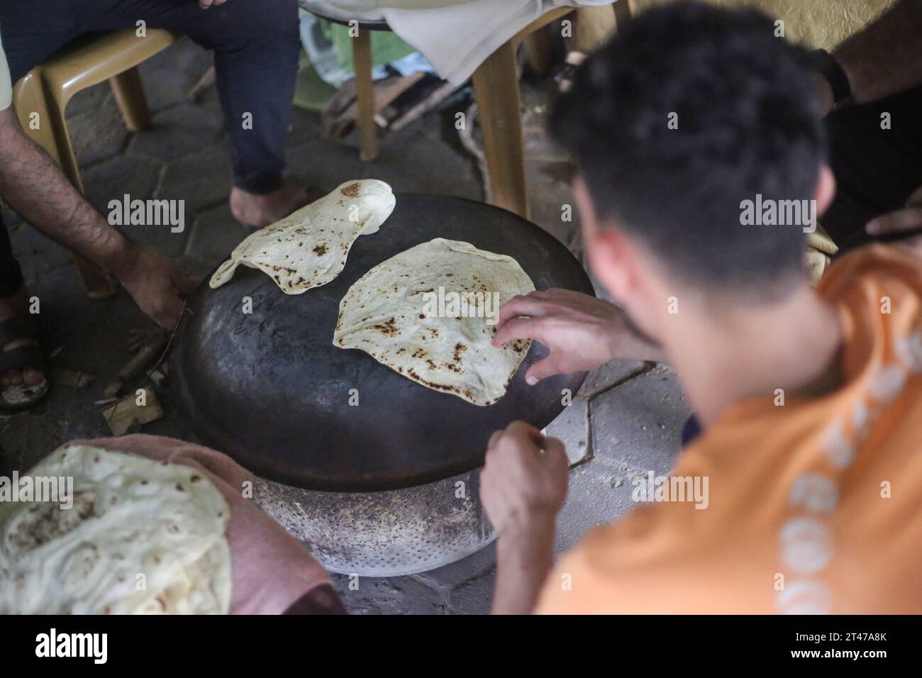 Gaza, Palestine. 28th Oct, 2023. Palestinians use firewood to make ...