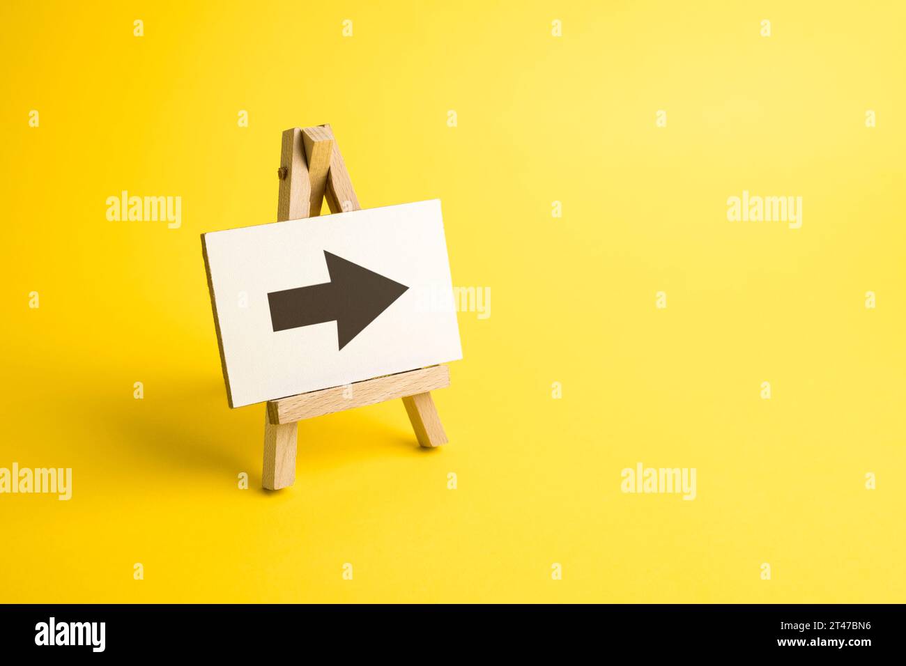 Arrow on easel. Advertising sign. Direction pointer. Hint, help in ...